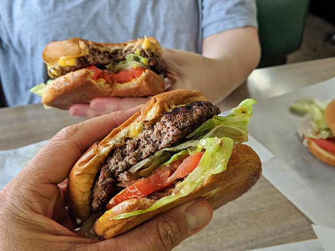Burger bliss, times two! These handhelds aren't just food, they're edible works of art that'll have you planning your next visit before you've finished the first bite.
