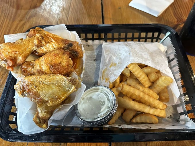 Golden-fried wings nestled beside crispy fries&mdash;a basket of happiness that makes you wonder why you'd ever eat anything else.