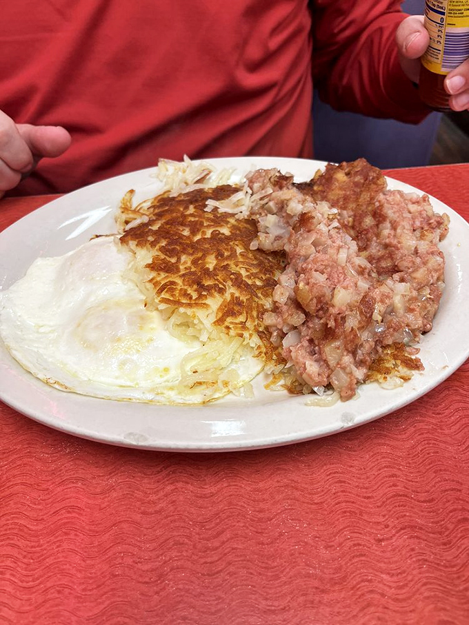 The holy trinity of breakfast: golden hashbrowns with edges crispy enough to make a satisfying crunch, eggs, and corned beef hash.