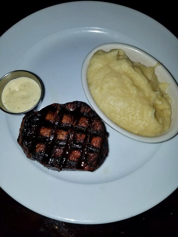 Diamond-patterned grill marks on a perfect steak beside cloud-like mashed potatoes. Some relationships are complicated; this one is pure harmony.