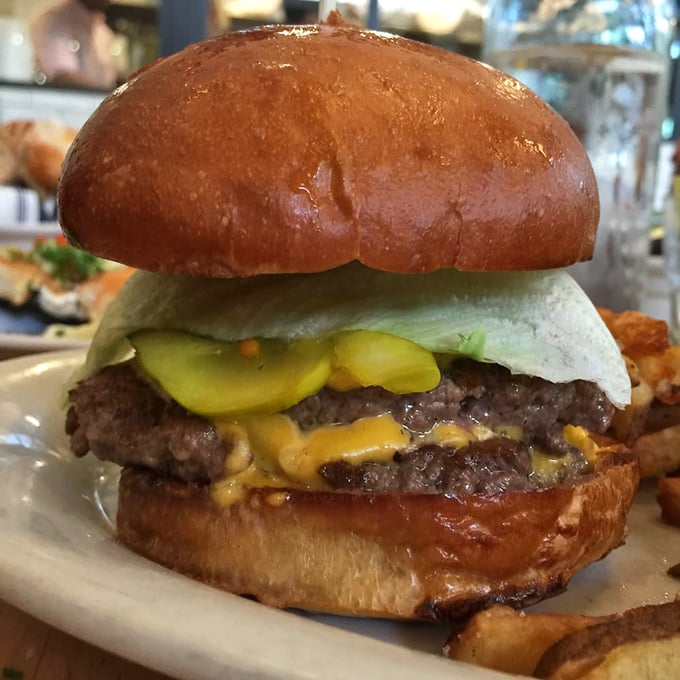 Burger bliss achieved! This double-decker delight is the Eiffel Tower of beef - tall, proud, and distinctly mouthwatering.