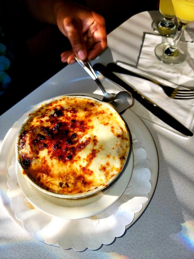 This isn't just French onion soup; it's a caramelized masterpiece under a blanket of broiled cheese that stretches with each spoonful.