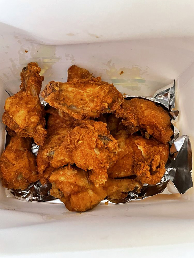 Fried chicken so perfectly golden it belongs in Fort Knox. The crust shatters with military precision, revealing juicy meat that surrenders instantly.