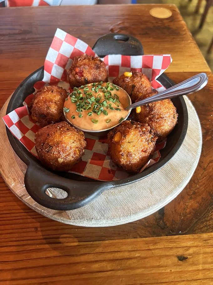 These aren't just hush puppies; they're crispy-outside, fluffy-inside flavor bombs surrounding a dipping sauce worth writing home about.
