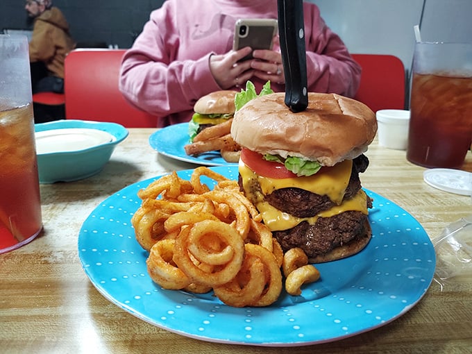 Holy cow! This burger is so tall, it needs its own zip code. Unhinge your jaw and prepare for flavor overload!