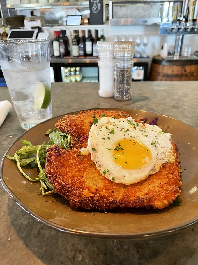 Schnitzel me timbers! This crispy chicken masterpiece, crowned with a sunny-side-up egg, is the Captain America of comfort food.