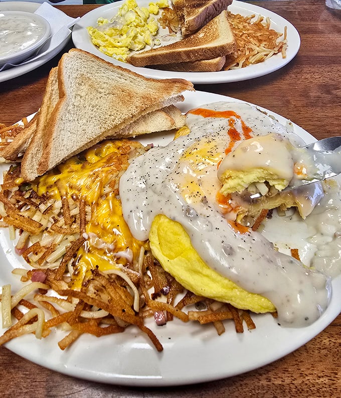 The breakfast trifecta: golden omelet, crispy hash browns, and a biscuit that could make your grandma jealous. It's the holy trinity of morning bliss.