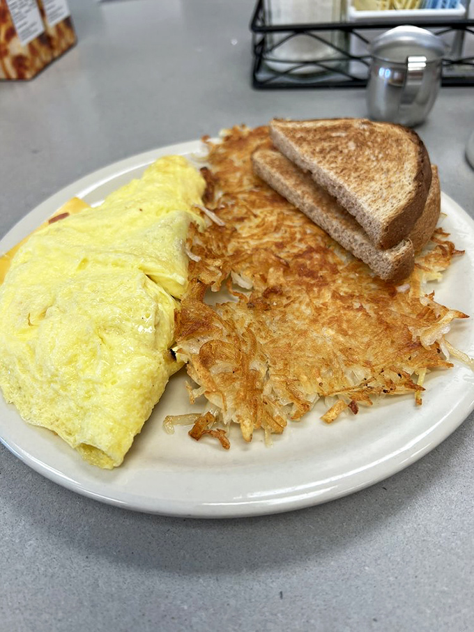 Eggs-cellence achieved! This omelet, paired with hash browns crispier than fall leaves, is a breakfast symphony in every bite.