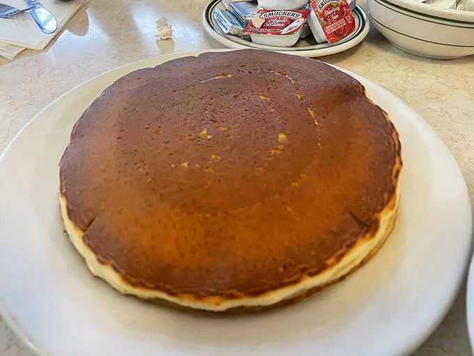 This pancake isn't just large&mdash;it's practically geological. Golden-brown, with the kind of surface texture that maple syrup dreams about at night.