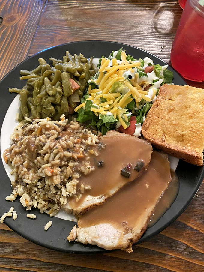 Southern comfort on a plate: roast pork with all the fixins. It's like a warm hug from your grandma, if she were a culinary genius.