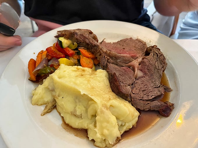 The holy trinity of dining: prime rib, mashed potatoes, and colorful veggies. It's like a balanced diet, but way more fun.