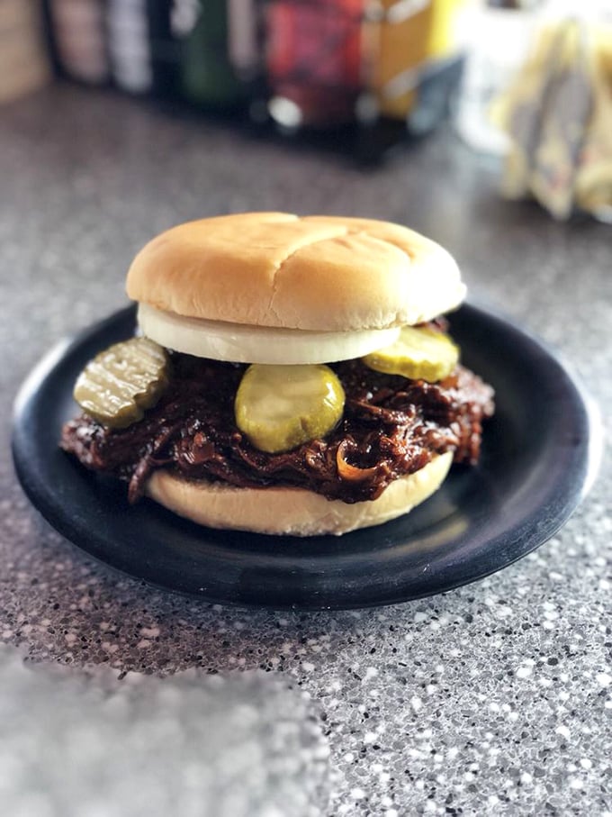 Holy smokes! This pulled pork sandwich looks like it could make a vegetarian weep. It's not a meal, it's a meaty masterpiece.
