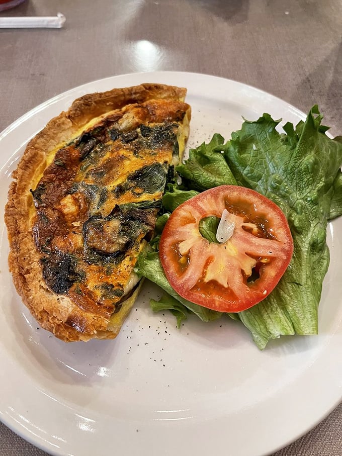Quiche me, you fool! This savory slice, paired with fresh greens, is the sophisticated brunch option you didn't know you needed.