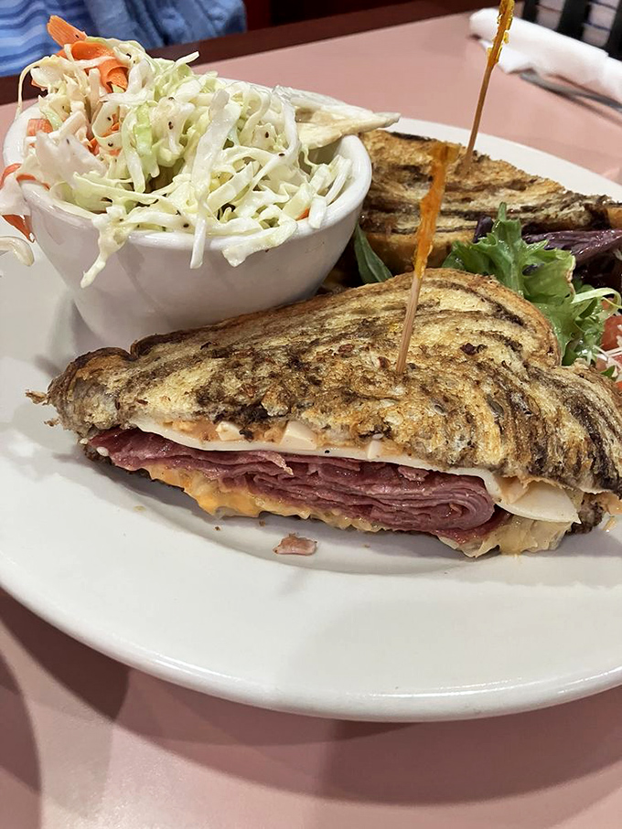 The Reuben: where corned beef meets its destiny. Piled high enough to make the Rat Pack proud, this sandwich is a testament to the power of good deli.