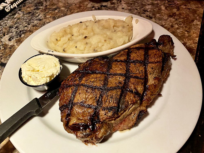 This rib eye steak is so perfectly grilled, it could make a vegetarian question their life choices. Mashed potatoes for moral support.