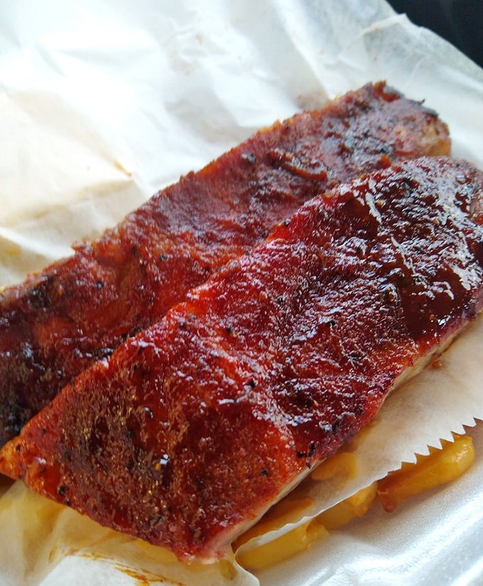 These ribs aren't just falling off the bone &ndash; they're practically filing divorce papers from it. The glossy sauce is just the lawyer making it official.