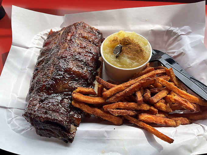 A plate that dreams are made of! Tender ribs, sweet potato fries, and a side that looks suspiciously like BBQ nirvana.