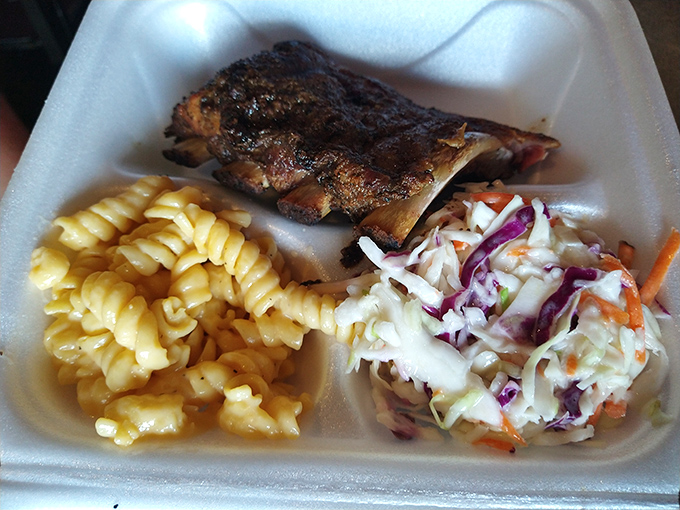 The holy trinity of BBQ: ribs, mac 'n' cheese, and coleslaw. It's like a hug for your taste buds, minus the awkward small talk.