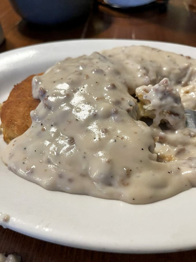This sausage gravy's thicker than the plot of a soap opera. It clings to the biscuit like it's afraid of heights.
