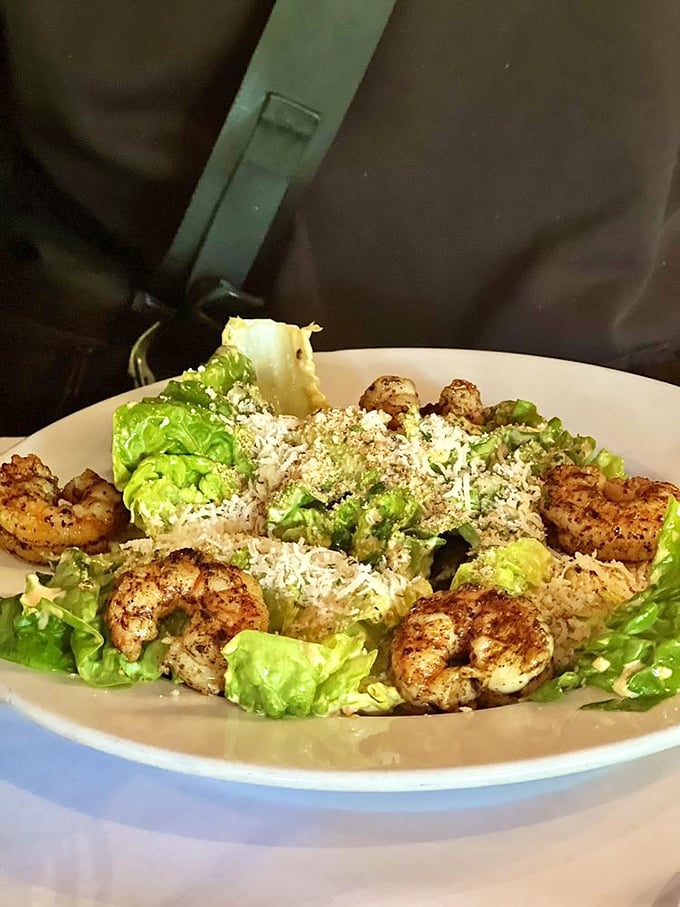 Plump, perfectly seasoned shrimp crown this Caesar salad like jewels, proving Oklahoma knows its seafood game despite being landlocked.