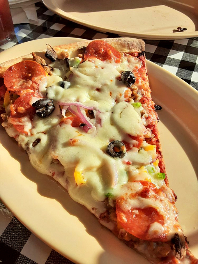 Behold the supreme ruler of slices! This pizza piece is so loaded, it's practically doing CrossFit on your plate.