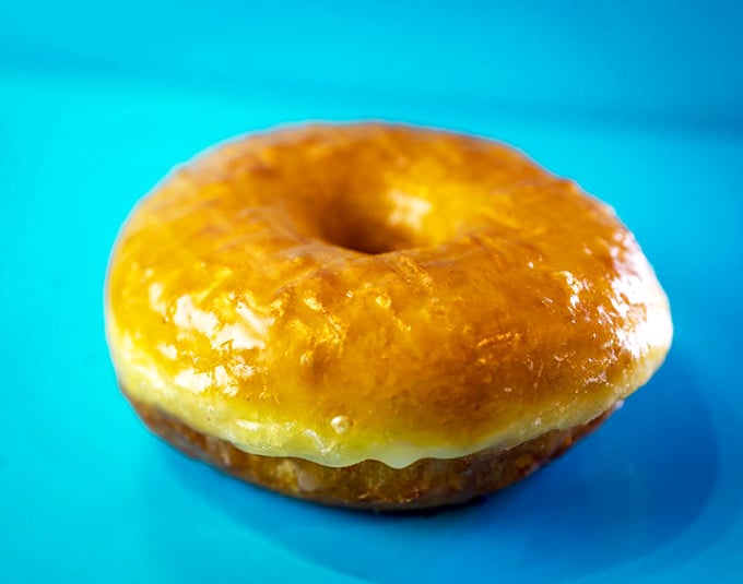 Behold, the golden child of donuts! This glazed beauty shines brighter than a tourist's sunburn on day one.