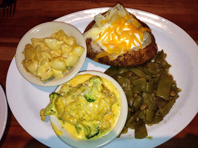A loaded baked potato, broccoli with cheese, and green beans—proof that vegetable plates don't have to be punishment for dietary sins.
