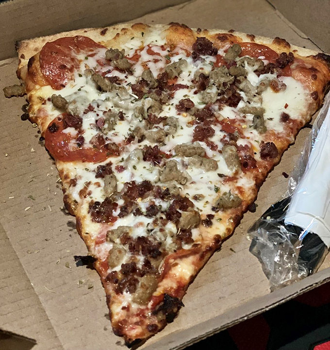 This slice is ready for its close-up, Mr. DeMille. Cheese stretches further than your imagination in this pizza perfection.