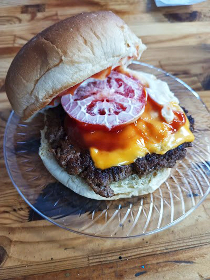 Holy cow! This burger's stacked higher than my to-read pile. It's a towering testament to the art of hand-held deliciousness.
