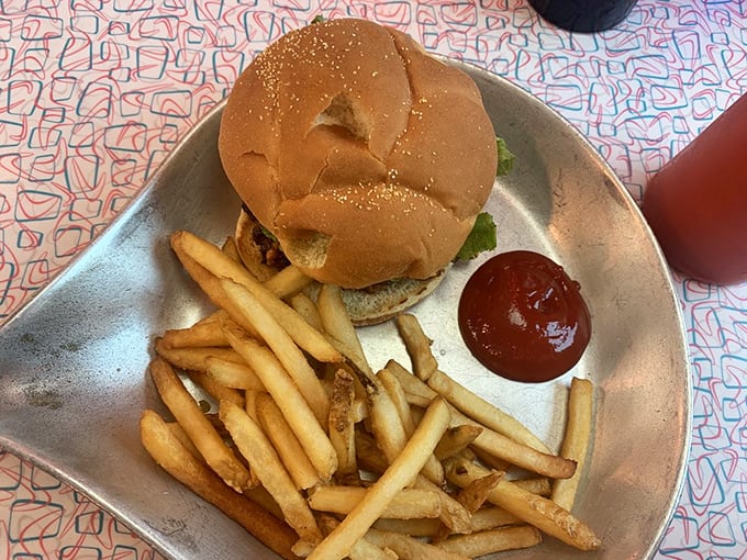 Burger bliss awaits! Golden bun, juicy patty, and a side of crispy fries. It's like a hug for your taste buds. Don't forget the ketchup!
