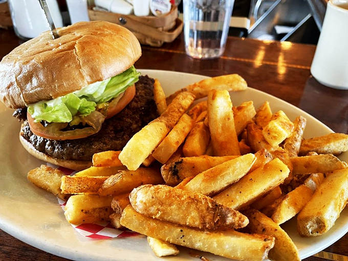 Burger bliss achieved! This towering masterpiece is the skyscraper of sandwiches, complete with a side of crispy, golden fry-scrapers.