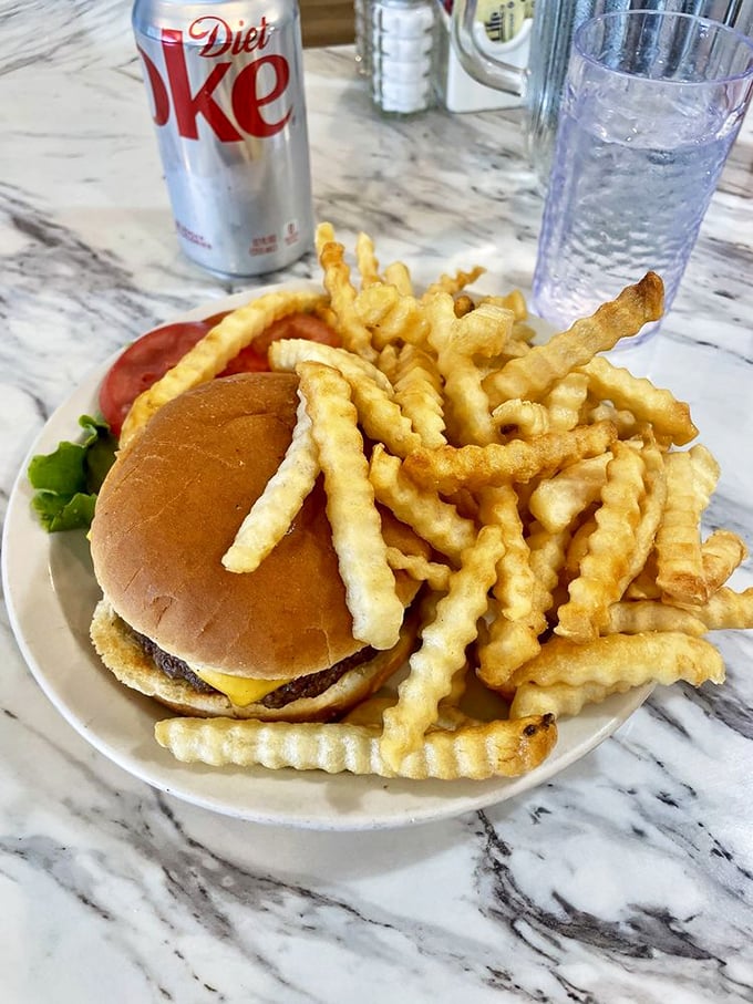 The classic American duo: burger and fries. This plate screams "comfort food" louder than your mom yelling "Dinner's ready!" on a summer evening.