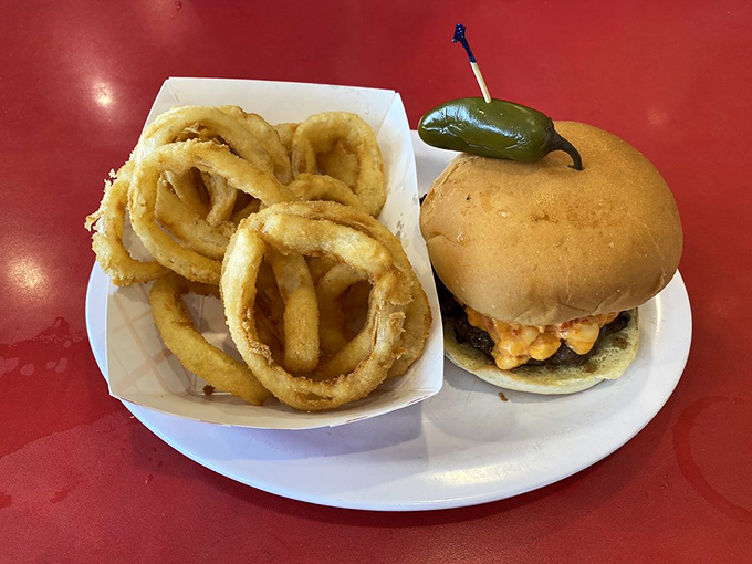 Holy cow, what a burger! This bad boy comes with a side of onion rings that could double as delicious golden bracelets.