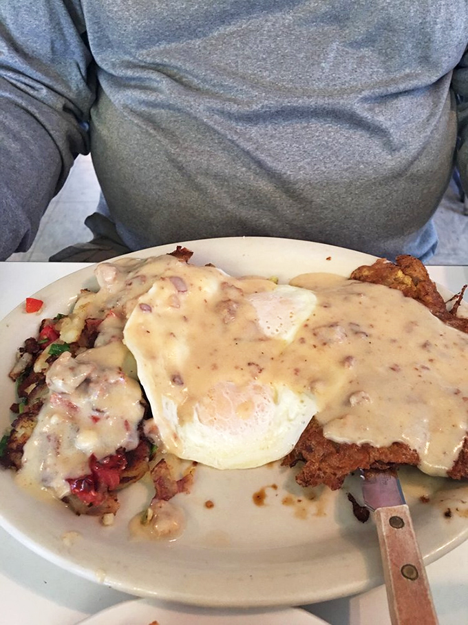 Beware the chicken fried steak – it's a crispy, gravy-laden siren song that'll have you planning your next visit before the first bite.