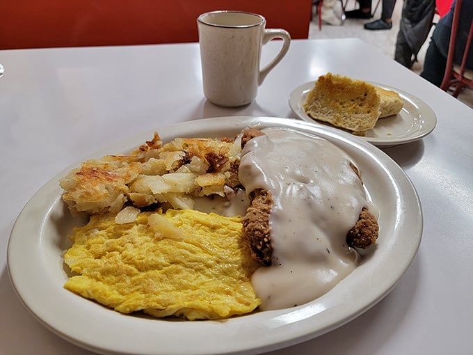 The breakfast of champions! This plate is a symphony of flavors - golden eggs, crispy hash browns, and chicken fried steak that could make a vegetarian weep.