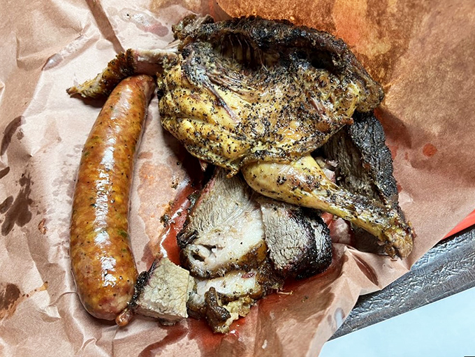 Finger-lickin' fantastic! This golden-brown bird and sausage combo is proof that in Texas, even the sides are main events. Time to get your hands deliciously dirty!