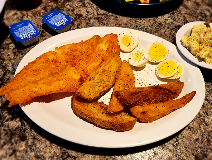 Golden-fried perfection alongside eggs and potatoes&mdash;the breakfast trinity that makes mornings worth facing. Even the plate looks happy.