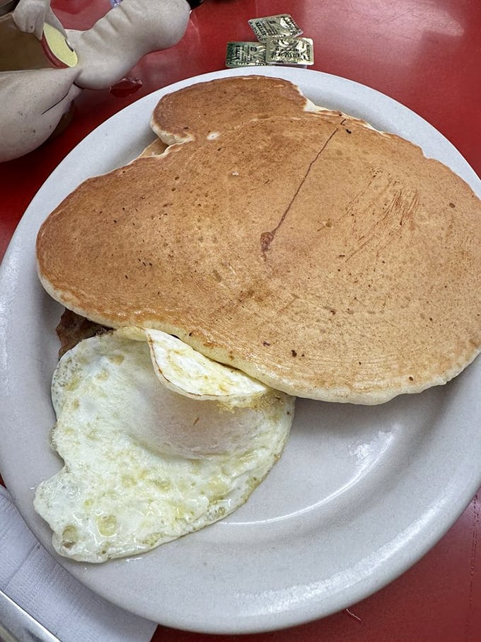 Pancakes so perfectly golden they deserve their own currency. That egg isn't just sunny-side up&mdash;it's beaming with breakfast joy.
