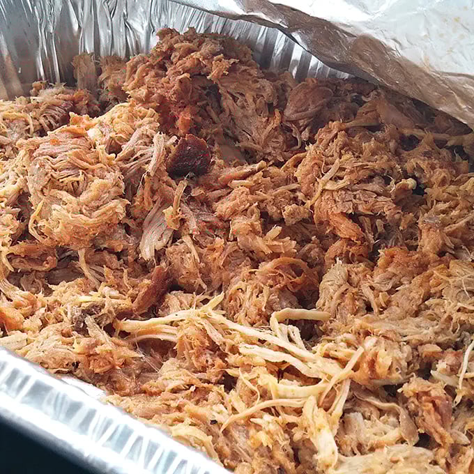 Behold, the holy grail of pulled pork! This aluminum tray holds enough smoky goodness to make you consider trading your firstborn for the secret recipe.