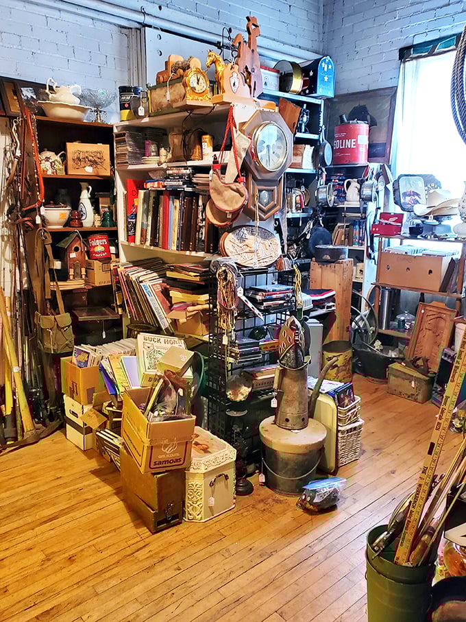 Books, knick-knacks, and is that a life-size cardboard cowboy? This shelf's got more layers than a archaeological dig site.
