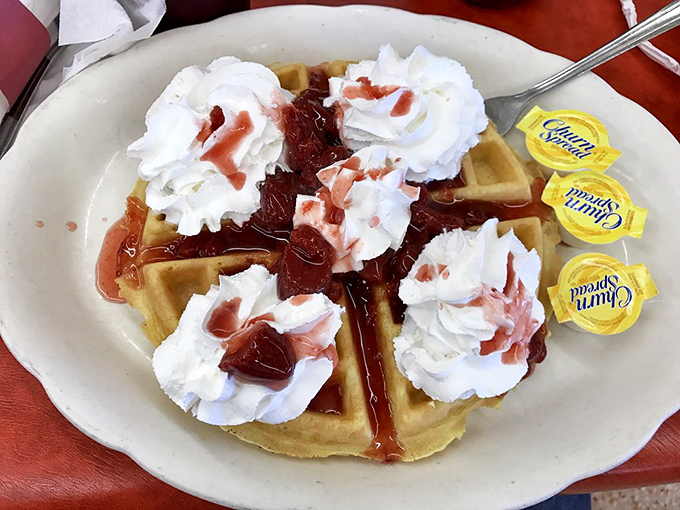 Waffle wonderland! This golden beauty is dressed to impress with whipped cream clouds and a berry compote that's singing "I Wanna Be Loved by You."