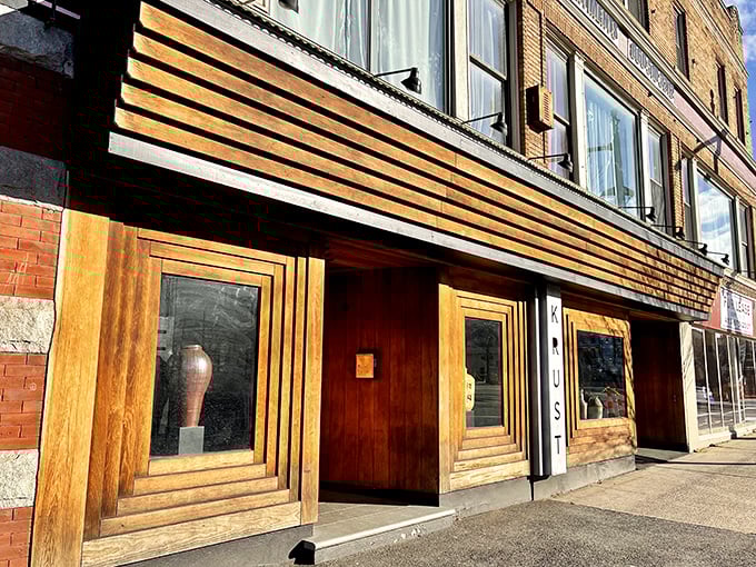 Krust Pizza & Bourbon Bar: Where hipster chic meets pizza perfection. Those wooden panels practically whisper, "Cool pizza inside!"