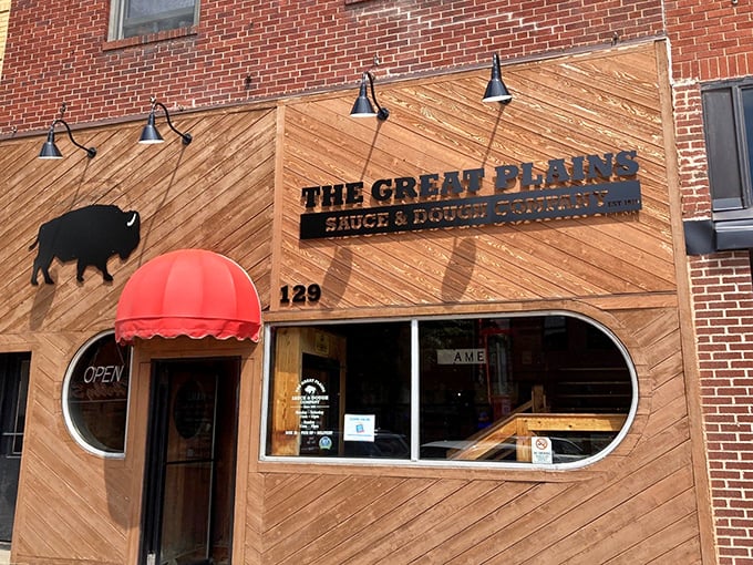 The red awning beckons like an old friend, promising pizzas so unique they've defied categorization since the disco era.