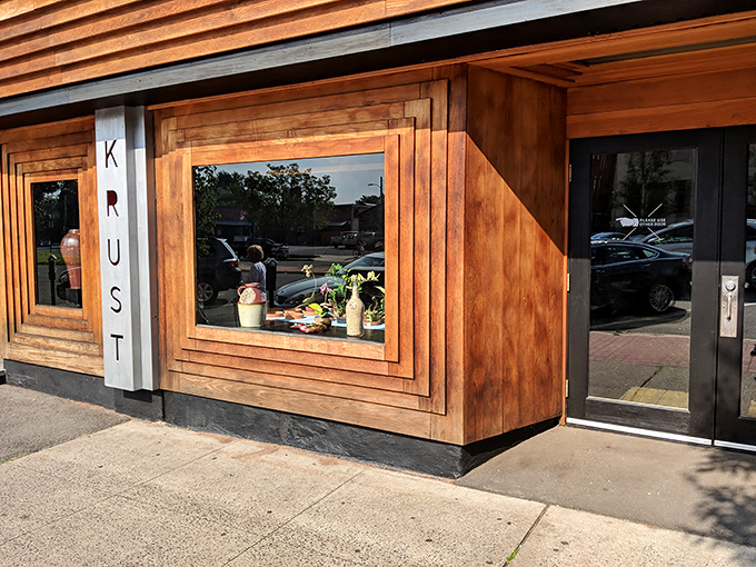 Krust's geometric windows offer a tantalizing glimpse into a world where pizza and bourbon live in delicious harmony.