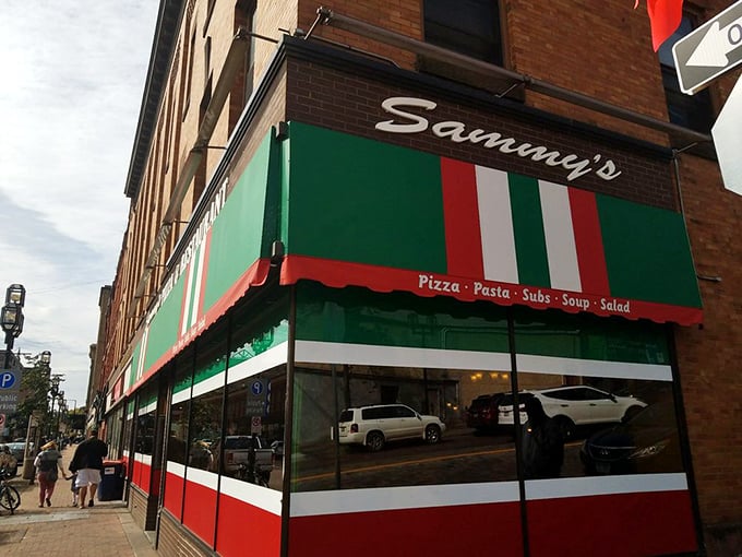 Sammy's Pizza storefront: Classic awnings and brick facade &ndash; it's been serving up slices since before pizza was cool. (Yes, there was such a time!)