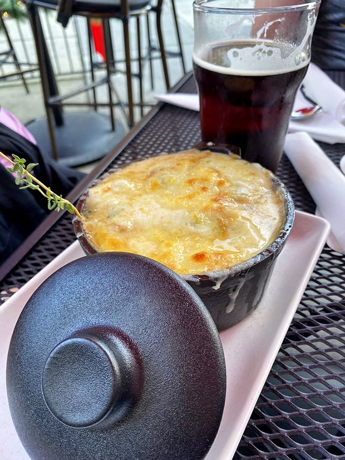 A match made in culinary heaven: rich French onion soup meets a pint of dark beer. It's like Romeo and Juliet, if they were delicious and had a happy ending.