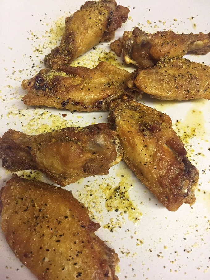 Lemon pepper wings that pack a zesty punch! They're like sunshine on a plate, but with more crunch.