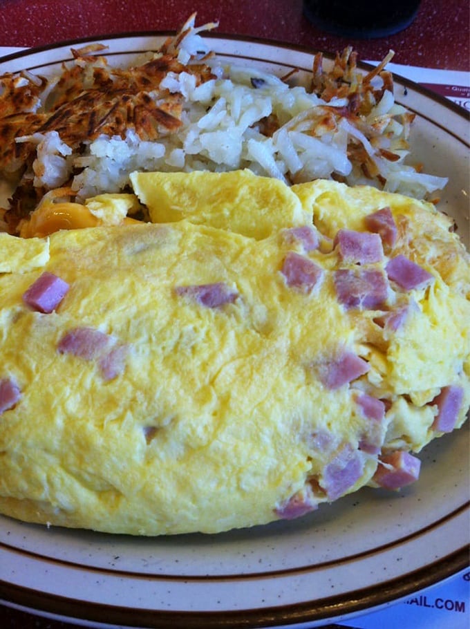 The dynamic duo: a golden omelet and crispy hash browns. Name a more iconic breakfast pair. I'll wait.