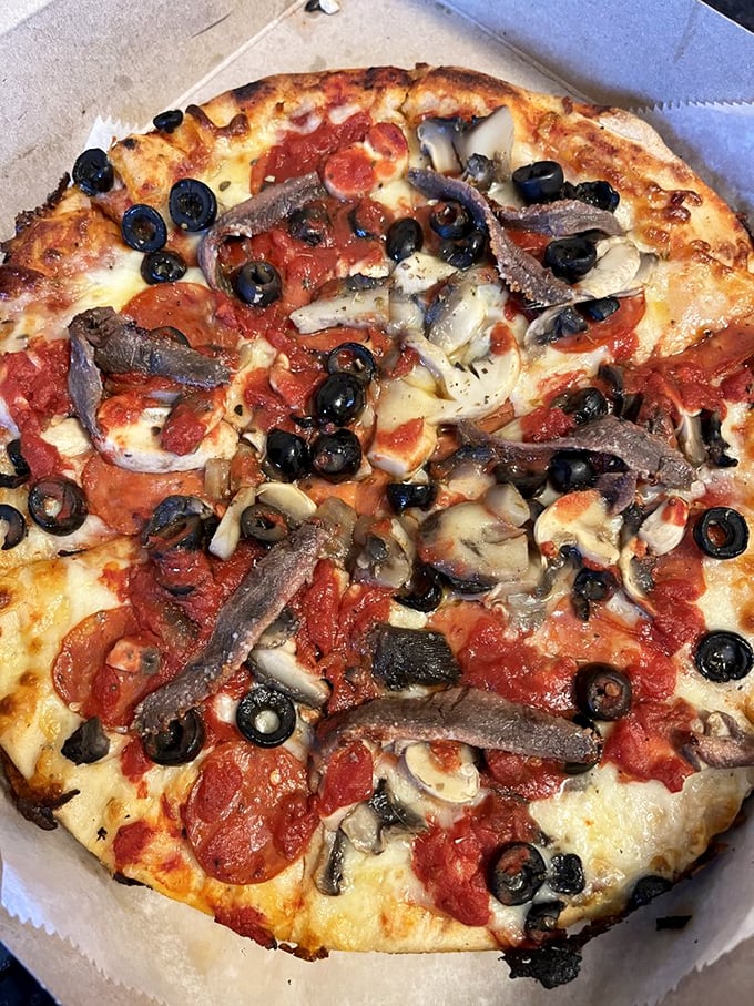 Anchovy lovers, rejoice! This briny beauty proves that sometimes, the best things in life come in small, silvery packages atop a perfect pizza canvas.