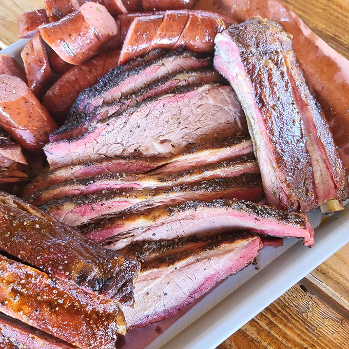 A carnivore's dream come true! This platter of pork ribs and sausage is like a meaty masterpiece painted by the BBQ gods.